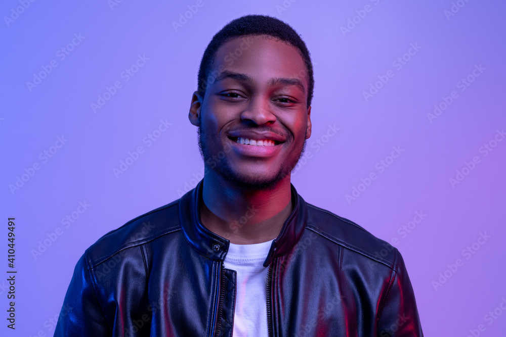 Portraif Of Happy Black Guy Posing In Leather Jacket Under Neon Light ...