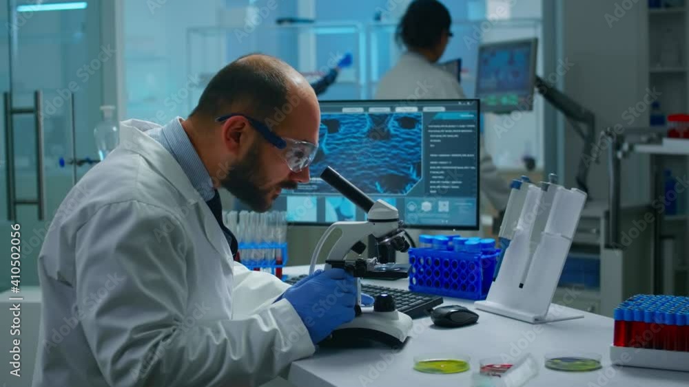 Medical research scientist conducting vaccine development under digital ...