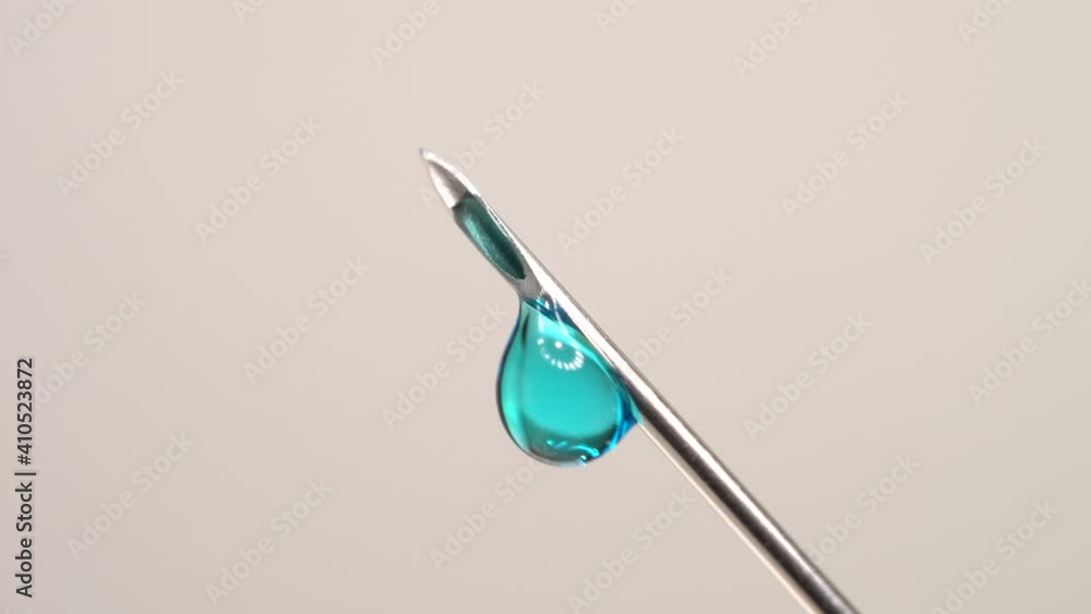 Cosmetic medication dripping from the syringe needle. Concept of beauty ...