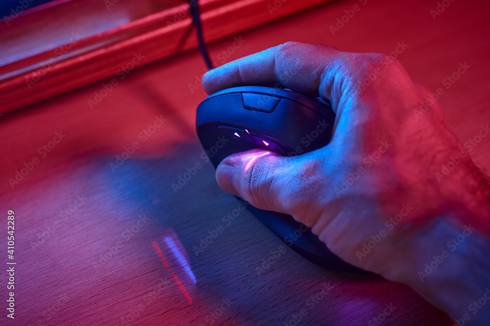 Male young hand lying on ergonomic gamer vertical mouse for computer ...
