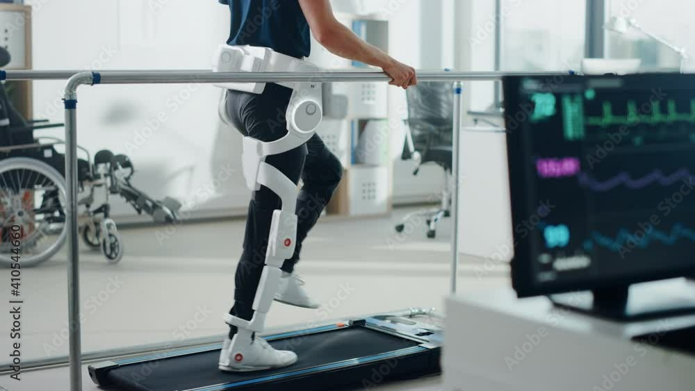 Modern Hospital Physical Therapy: Patient with Injury Walks on ...