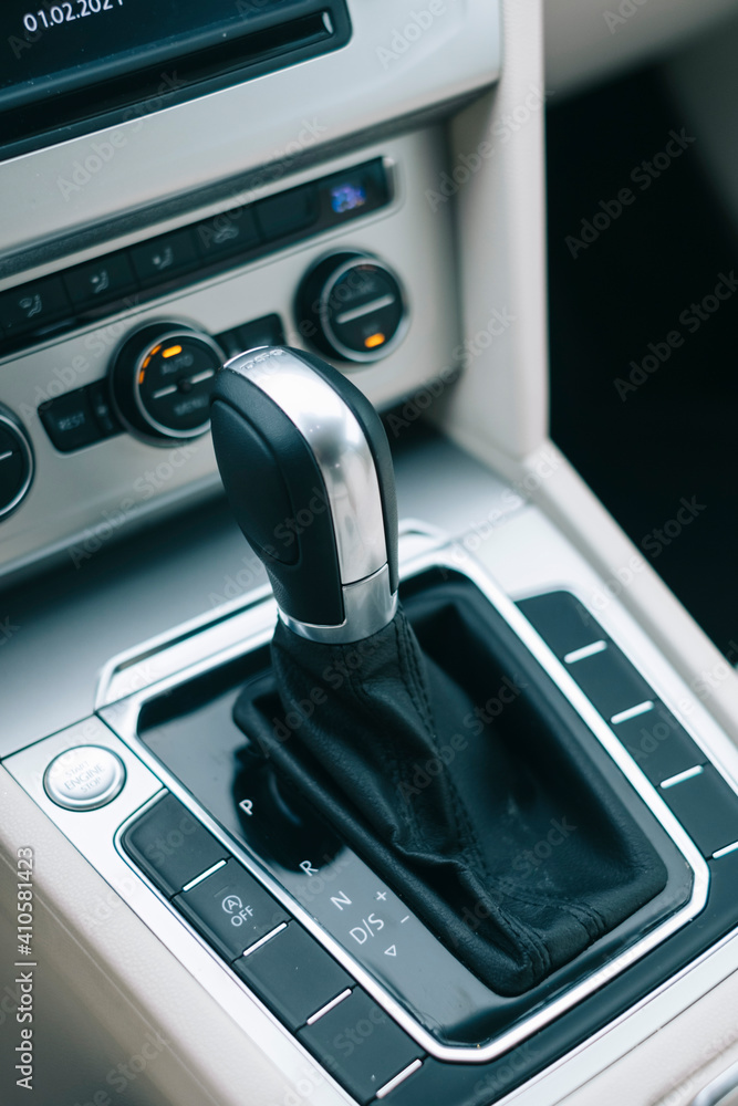 Car inside, automatic transmission close up, cup holders and armrest ...