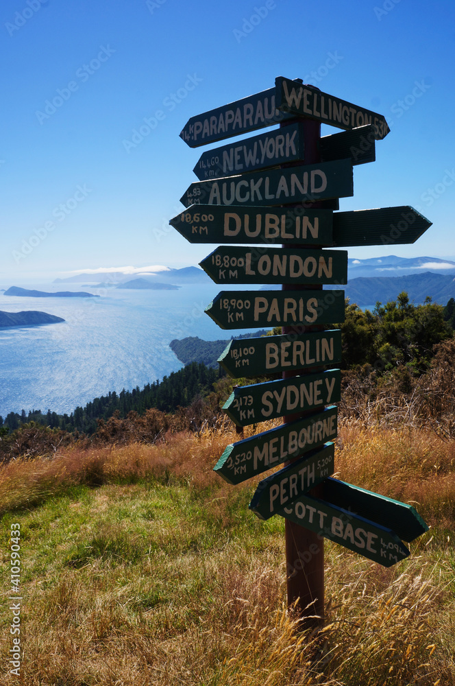Wooden signpost in Queen Charlotte Track showing distance to ...