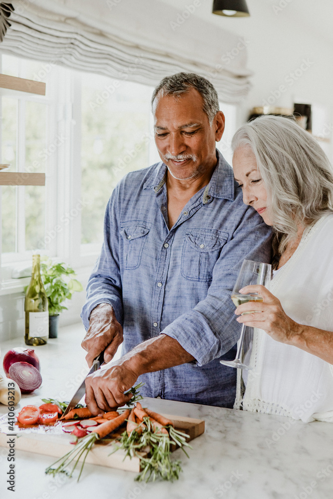 Elderly couple cooking in a kitchen Stock Photo | Adobe Stock