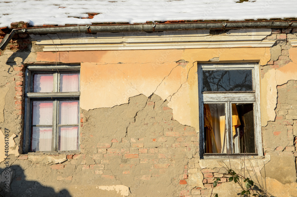 Cracked facade on house after devastating earthquake. Demolished house ...