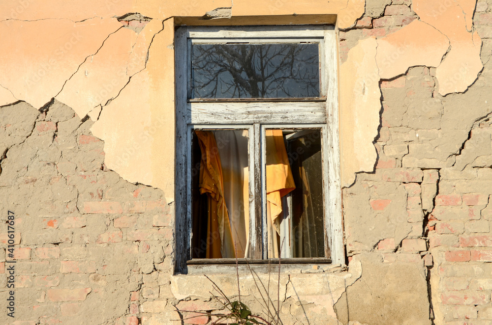 Cracked facade on house after devastating earthquake. Demolished house ...