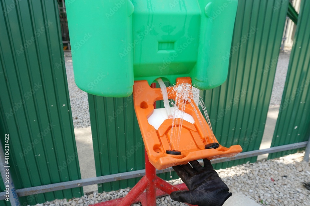 Workers are activating eye wash station for emergency use at ...