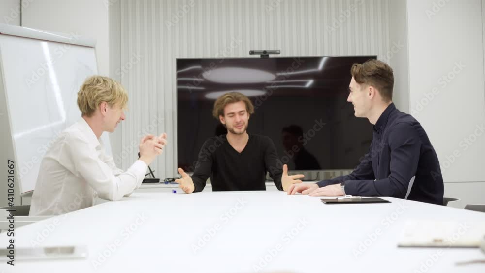 Nervous stressed man hitting table and talking to colleagues arguing on ...