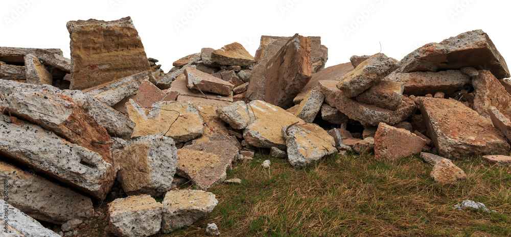 The ruins of concrete and brick rubble with green and dry grass ground ...