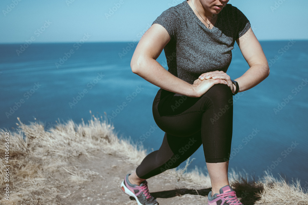 Sporty woman stretching legs and thigh muscles doing lunge exercise ...