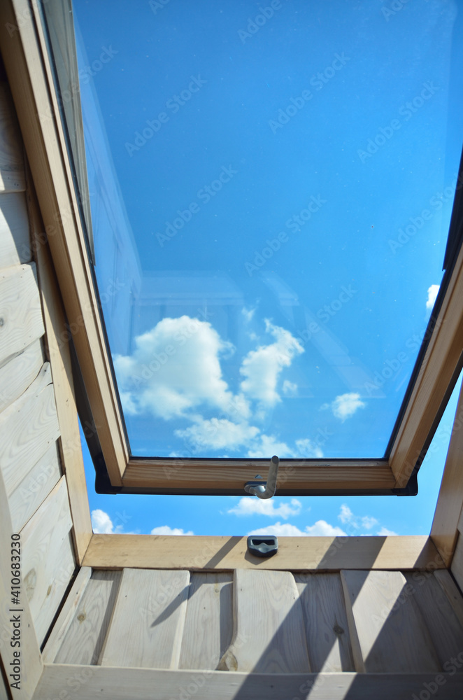 open roof window, skylight. A wide-open window of a full skylight looks ...