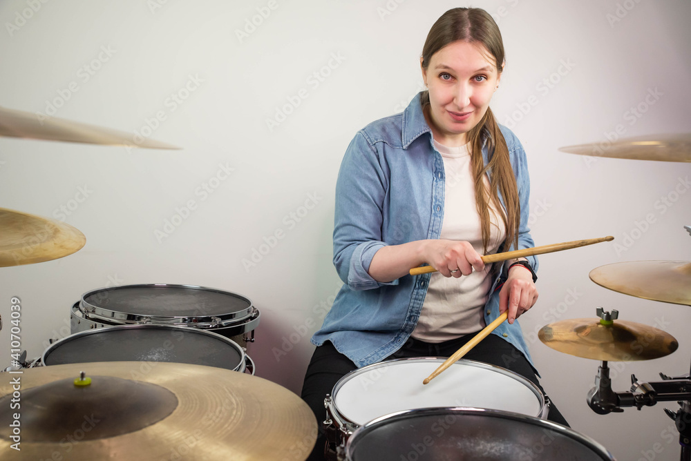Professional drum set closeup. Beautiful young girl drummer with ...