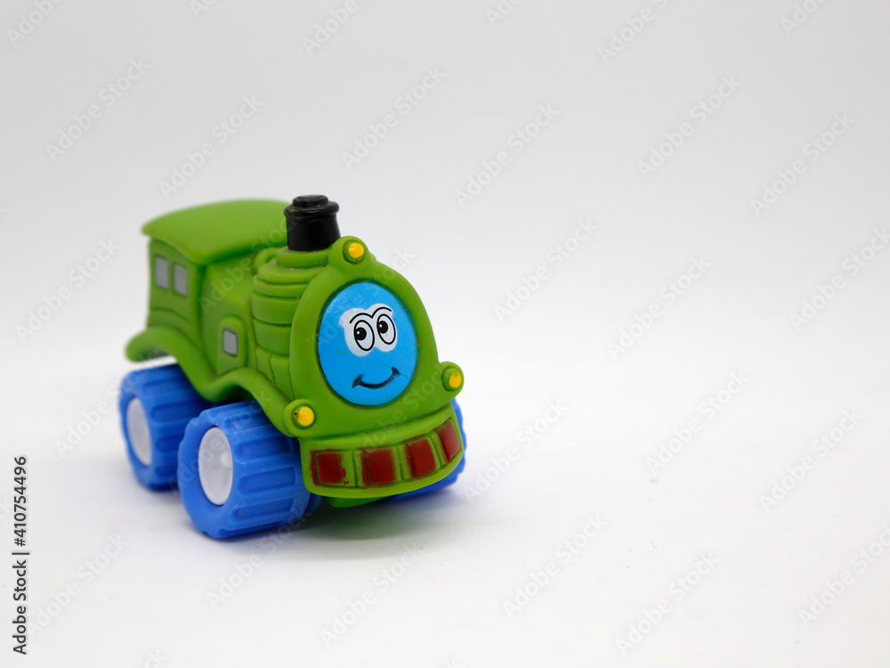 Plastic toy train for children with human faces. Train with a friendly ...