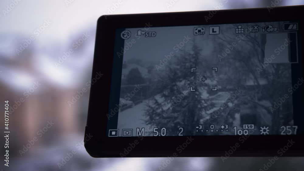 Watching the heavy blizzard in UK through a camera display, snow ...