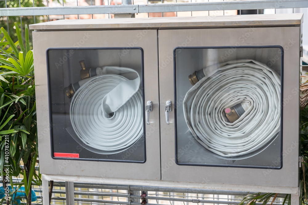 Fire hose cabinet. White hose in the water drawer to extinguish the ...