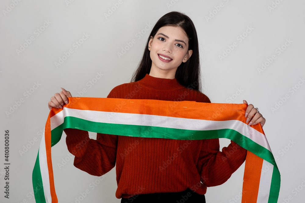 Portrait of a young beautiful female holding a long scarf with colours ...