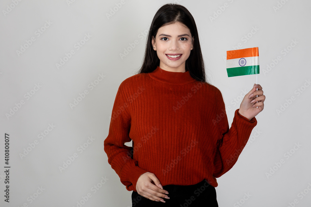 Portrait of a young beautiful female holding the Indian flag, tricolour ...