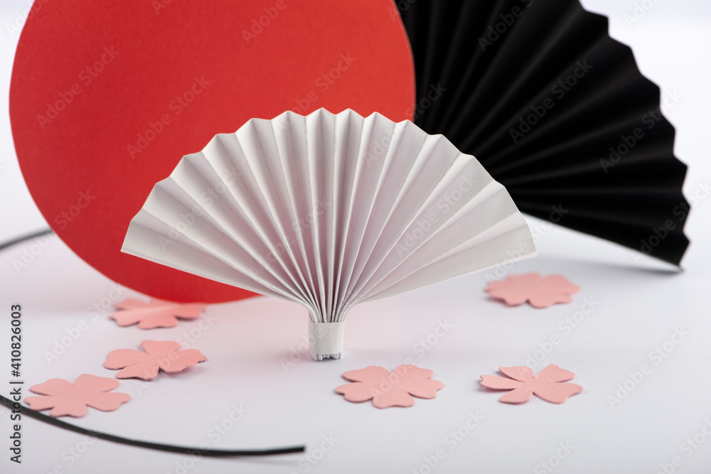 Red sun, pink flowers and origami paper fan isolated on white ...