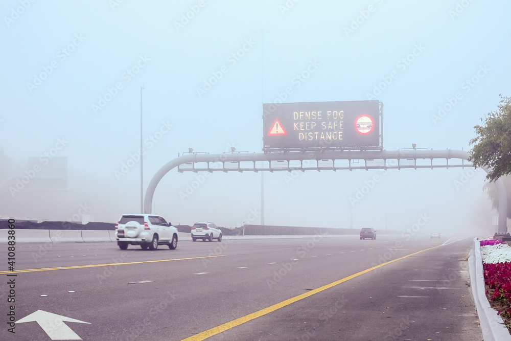 Road in the fog, sign mention keep distance for motorists at dubai road ...