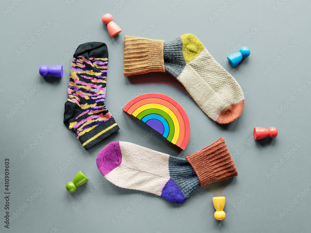 Odd Socks Day. Mismatched socks and rainbow toy. Social initiative against bullying in school or ...