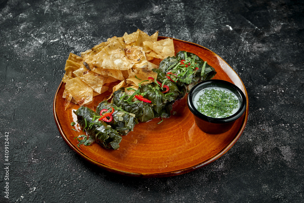 Dolma is a national Caucasian dish. Minced meat wrapped in grape leaves ...