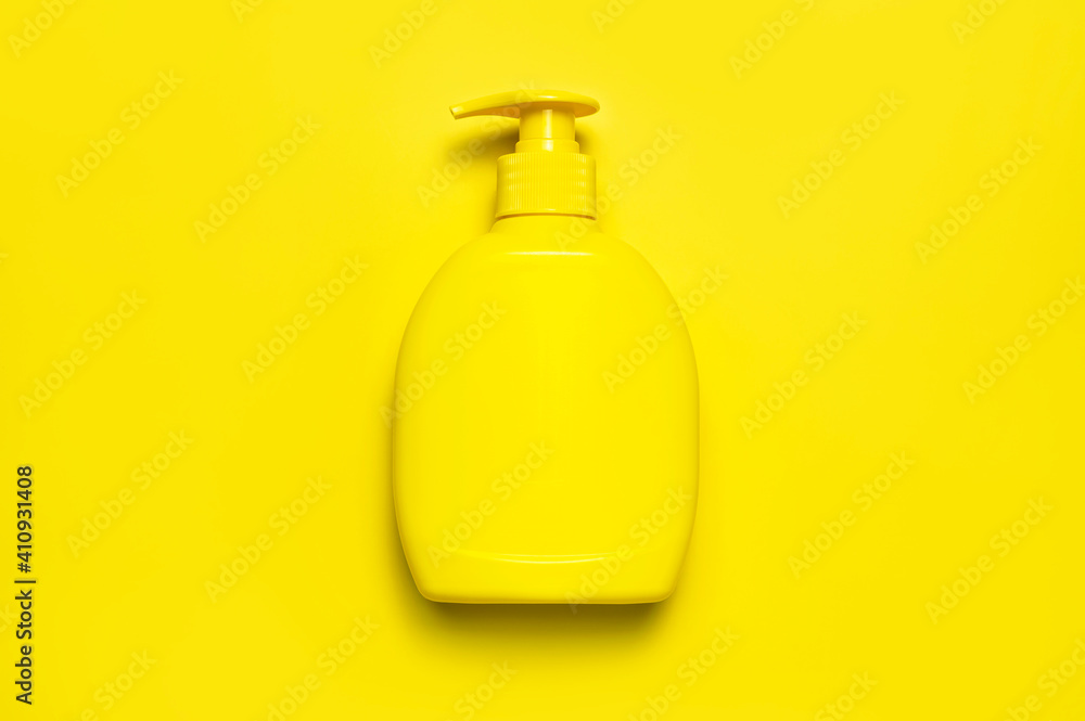 Yellow plastic cosmetic bottle container with dispenser on yellow ...