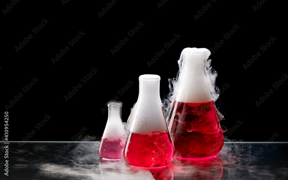 White smoke comes from a erlenmeyer flasks with red solution after ...