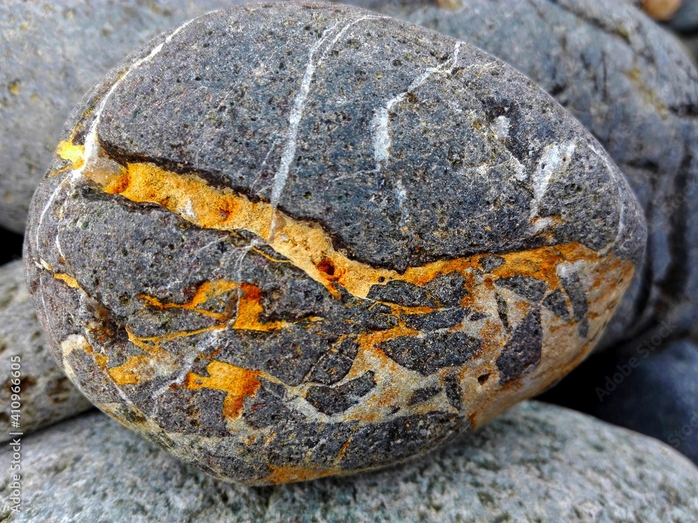 Gray gold rock stone on pebble river beach background. Rough stone ...