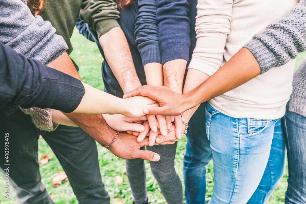 Closeup of multiracial people putting hands on stack - Group of friends ...