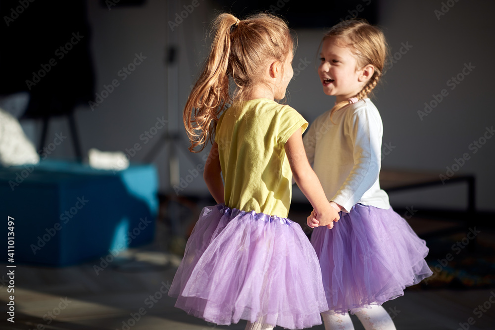 Little sisters dancing at home together. Children, playing, home ...