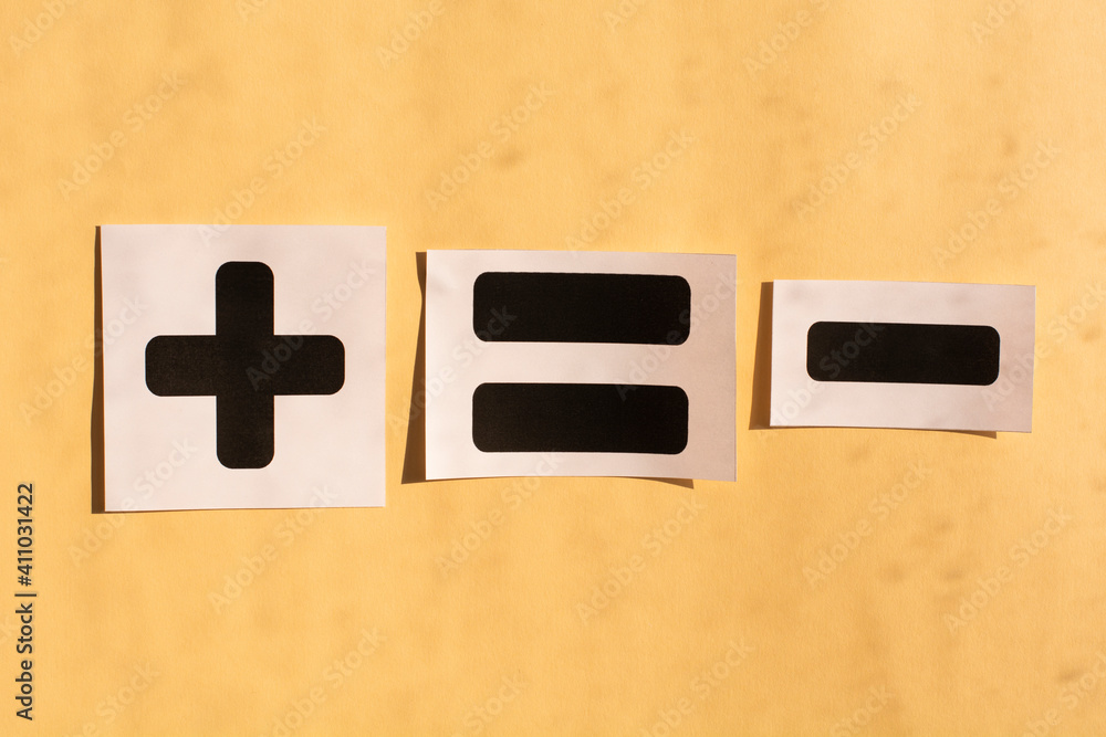 Symbols of black color plus, minus and equals on beige background ...