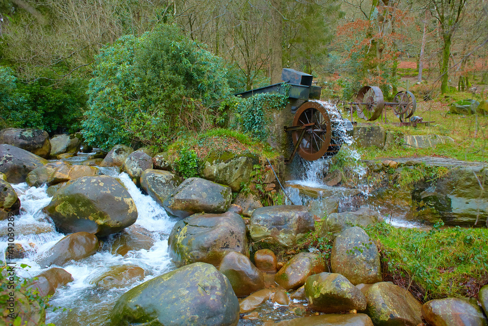 Working water mill wheel with falling water in the village. Stock Photo ...