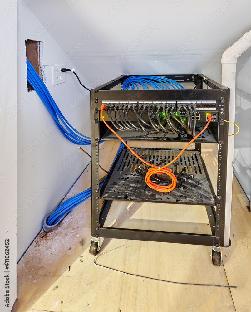 Rack mounted switch connected to network cables routed throughout both ...