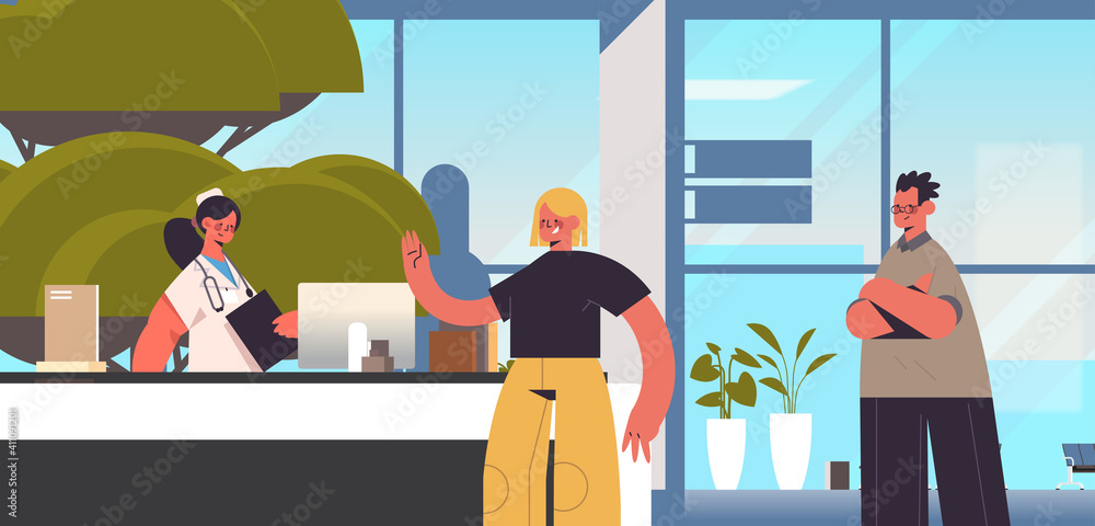 patients standing line queue at reception counter with receptionist ...