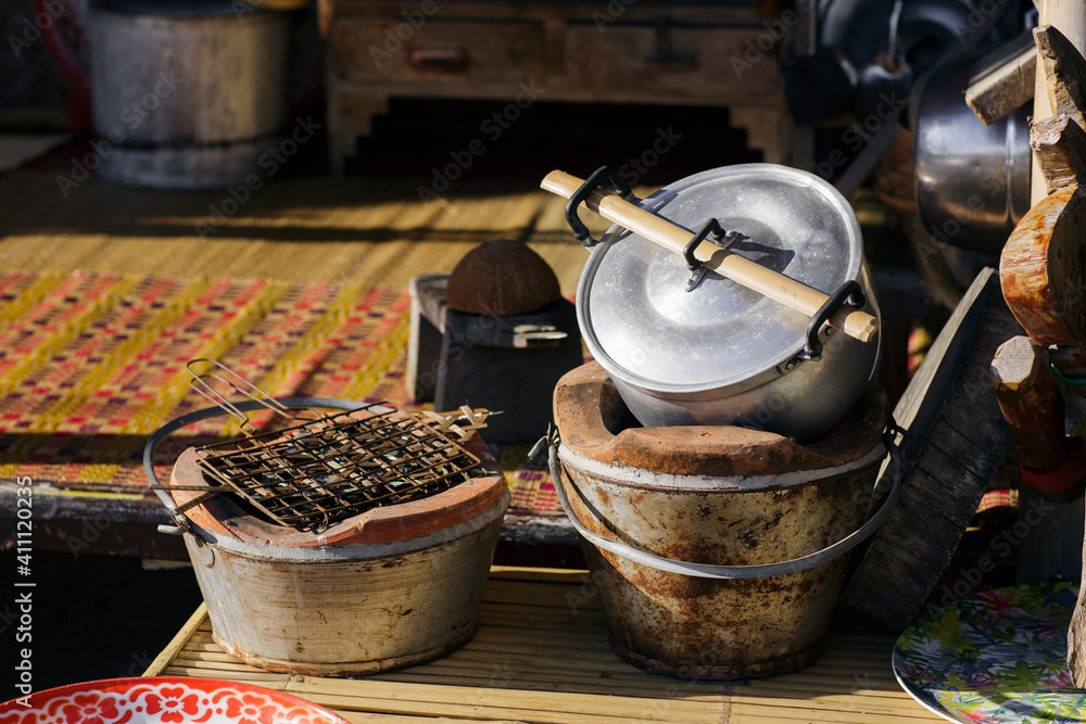 Rice cooker and grill. Cooking utensils in the kitchens of rural ...