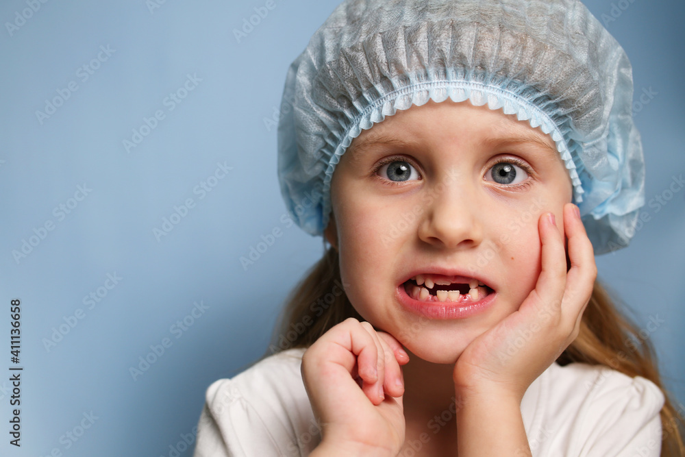A little girl at the dentist shows a toothless mouth. Replacement of ...