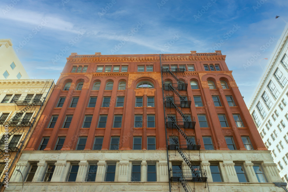 An upward, frontal view of an office building with rusticated sandstone ...