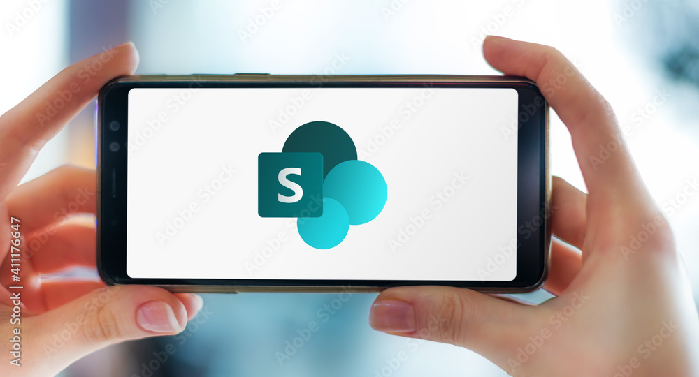 Hands holding smartphone displaying logo of SharePoint Stock Photo ...