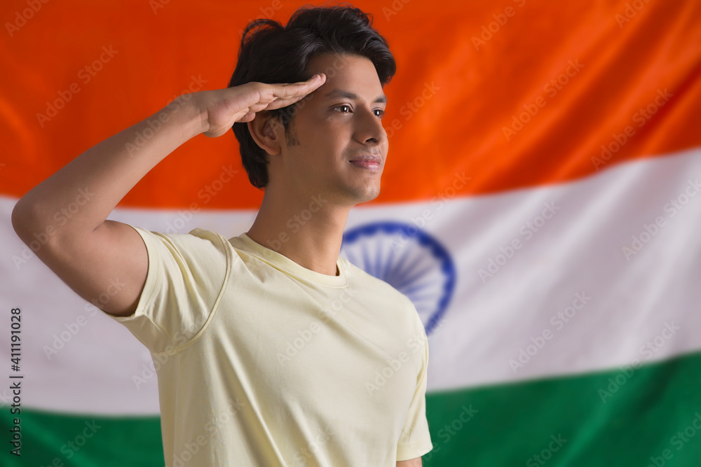 young man saluting in front of indian flag, independence day foto de ...