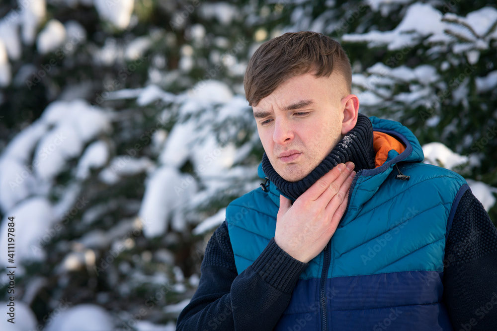 Sick ill guy, young man suffering from pain in throat, holding his neck ...