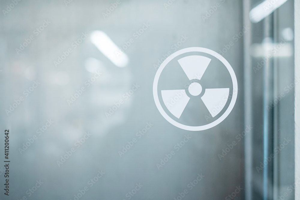 Radiation zone sign sticker on window of laboratory room. Health and ...