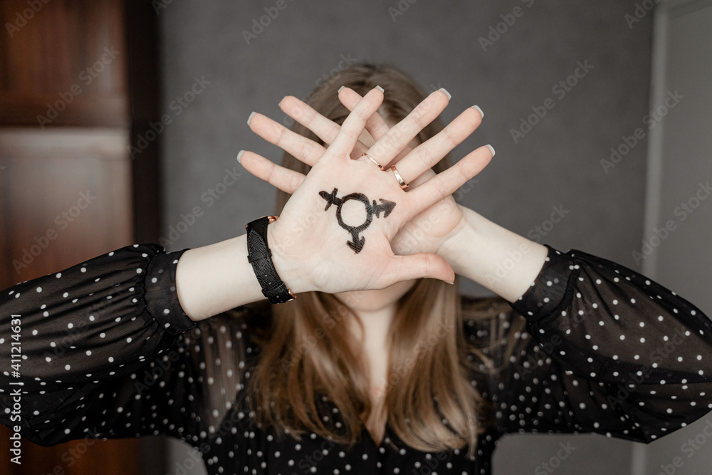 The girl shows on her hand the combined symbol of androgyne and ...