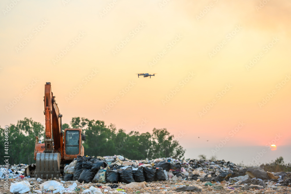Flying drone pilots take pictures of the garbage pile. To explore the ...