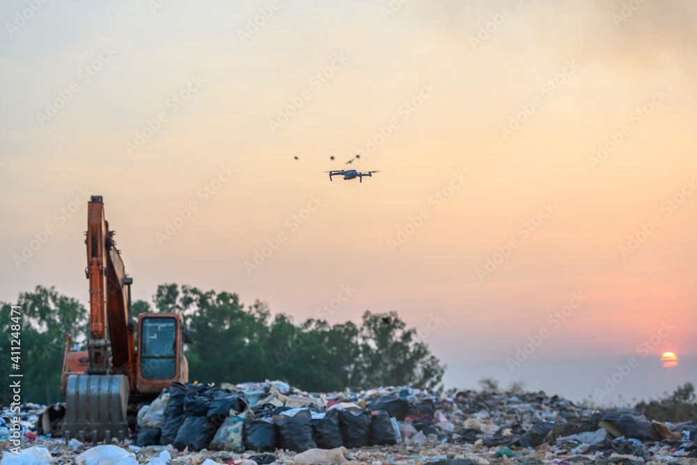 Flying drone pilots take pictures of the garbage pile. To explore the ...
