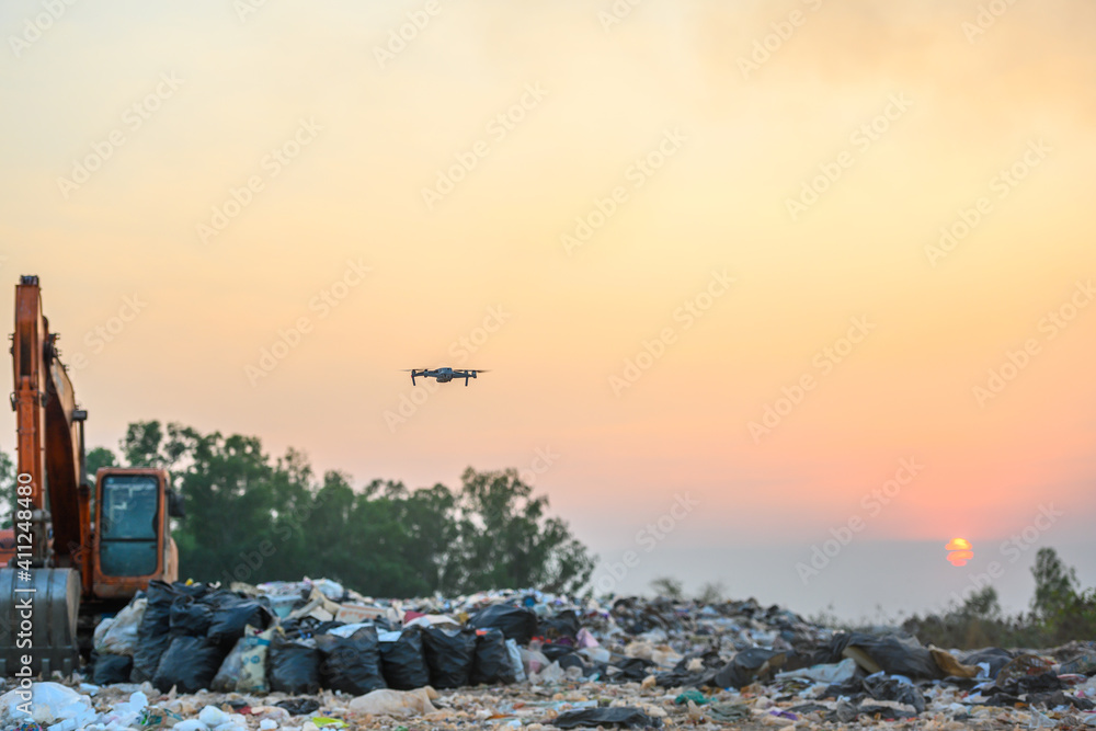 Flying drone pilots take pictures of the garbage pile. To explore the ...
