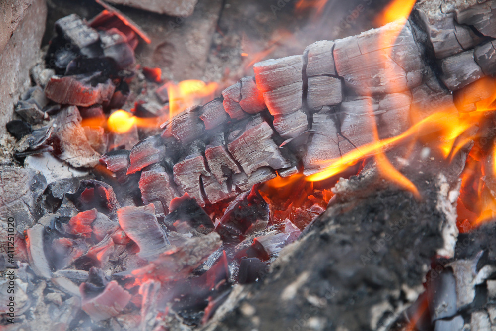 Foto de Glowing embers in hot red color, abstract background. The hot ...
