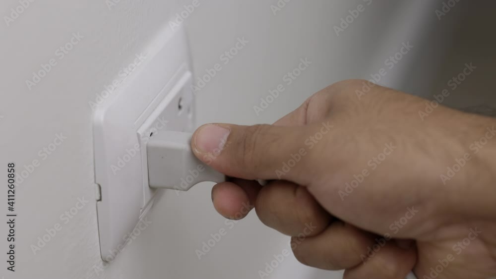 Hand holding Electric plug put on multiple socket. Electrical equipment ...