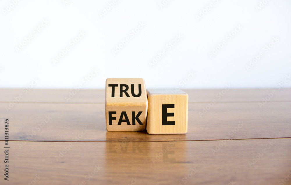 Fake or true symbol. Turned a wooden cube and changed the word 'fake ...