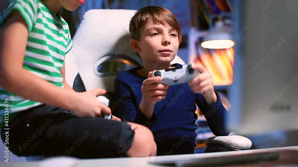 Preparing to start a video game ps4. The boy takes a joystick in his ...