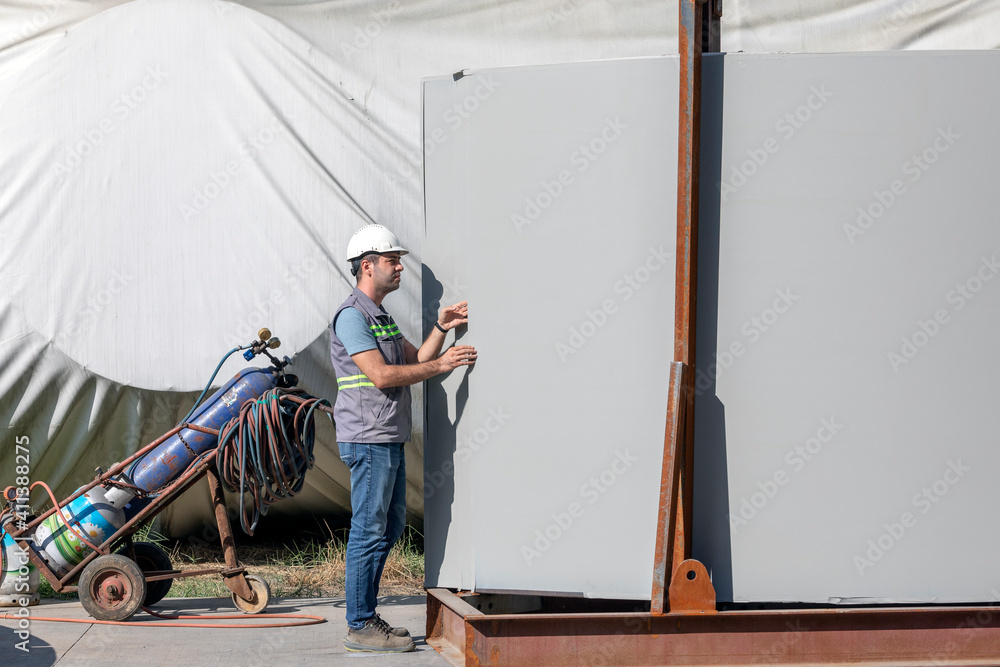 Quality control engineer is checking to steel welded manufactures ...